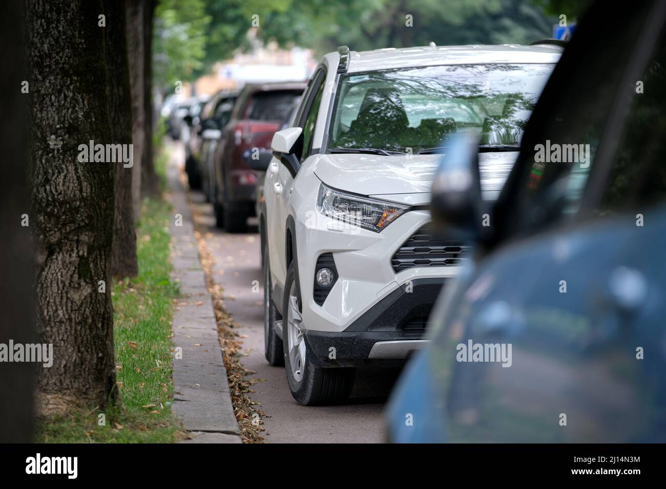 Cars parked in line on city street side. Urban traffic concept Stock ...