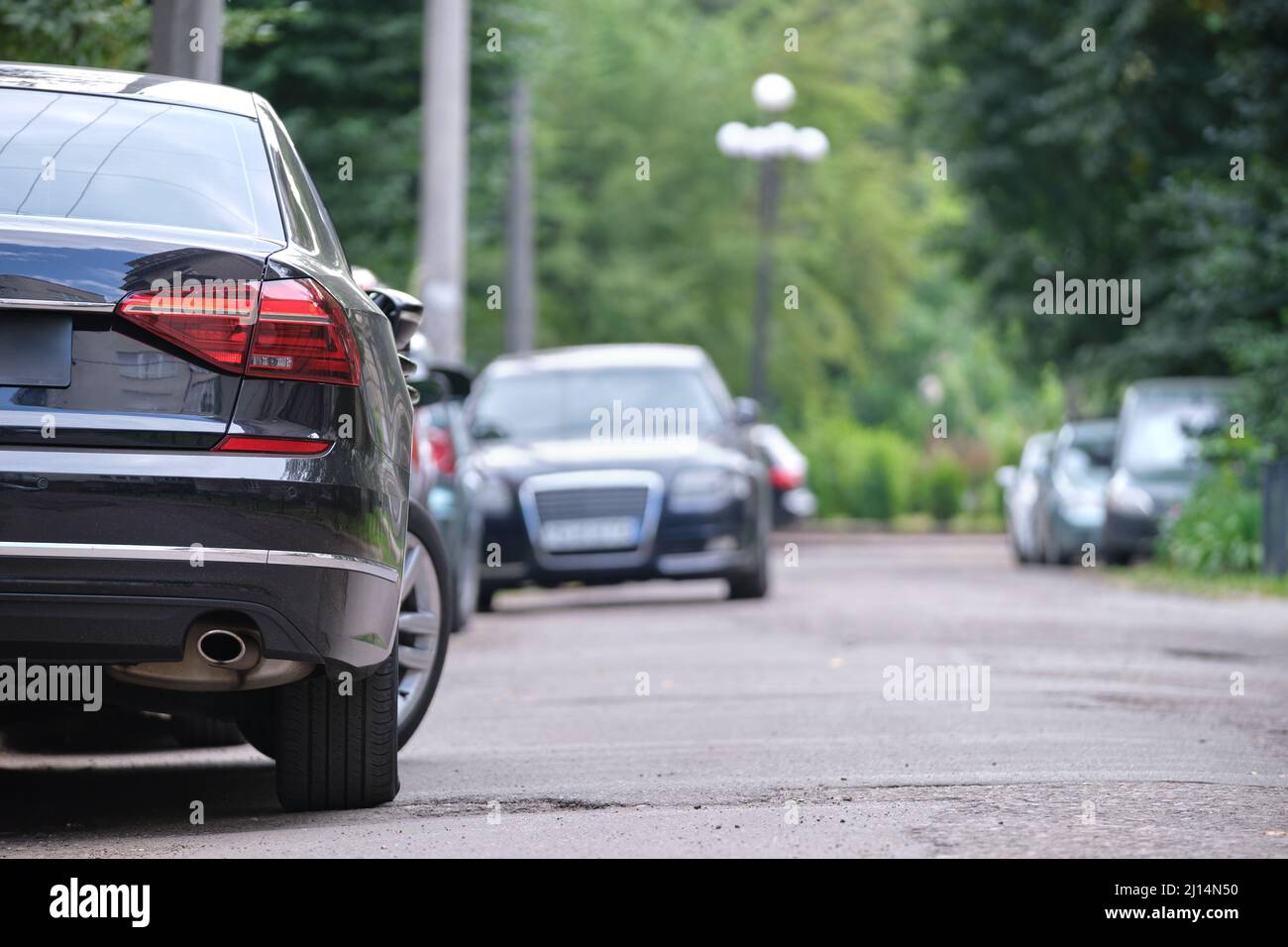 Cars parked in line on city street side. Urban traffic concept Stock ...