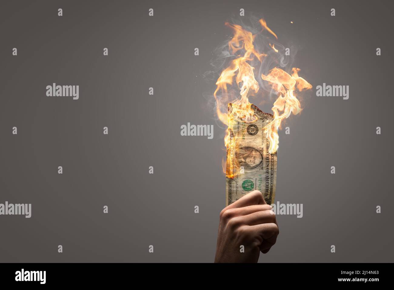 Burning US Dollar bill held by a hand Stock Photo - Alamy