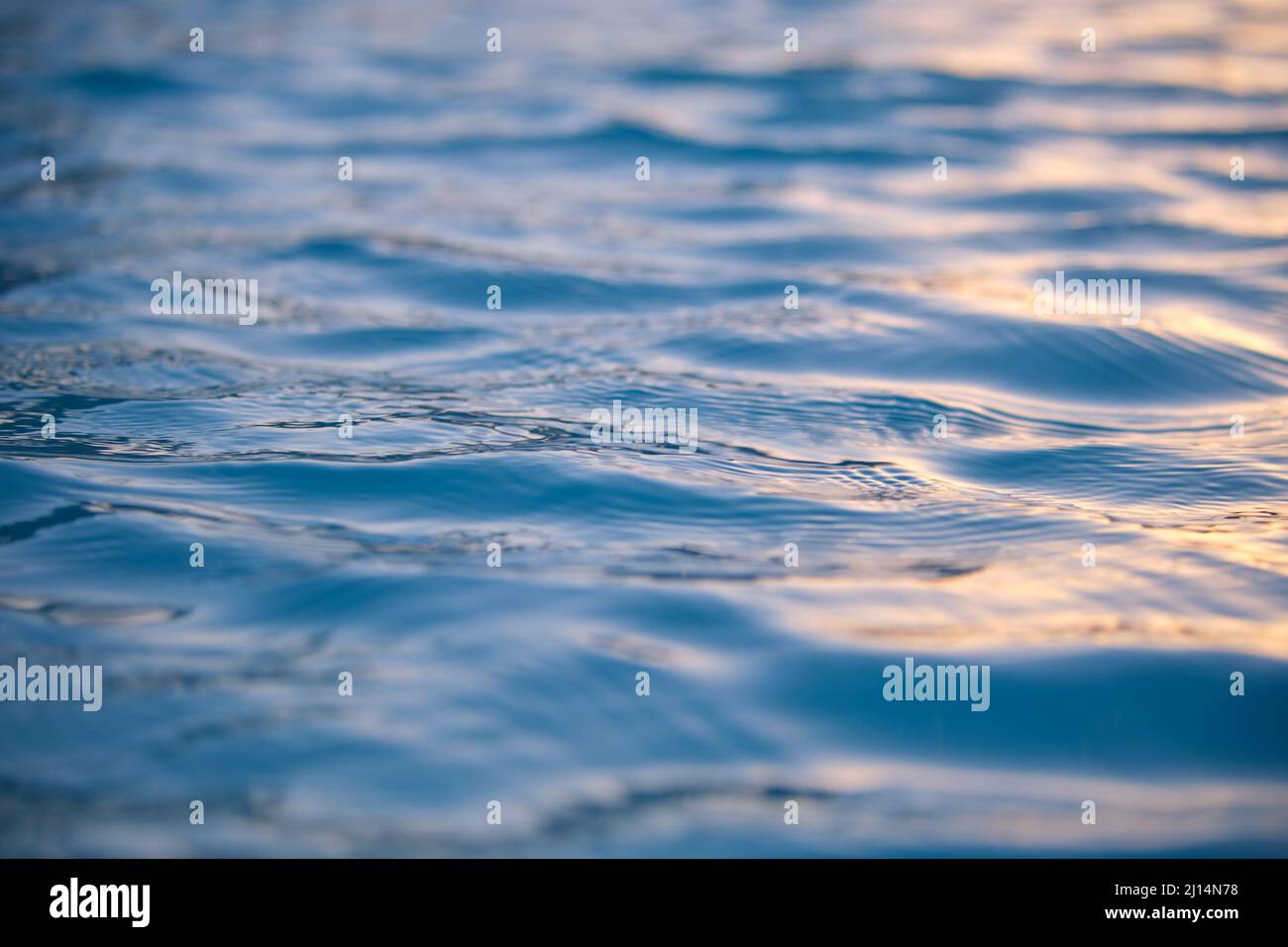Closeup seascape surface of blue sea water with small ripple waves ...