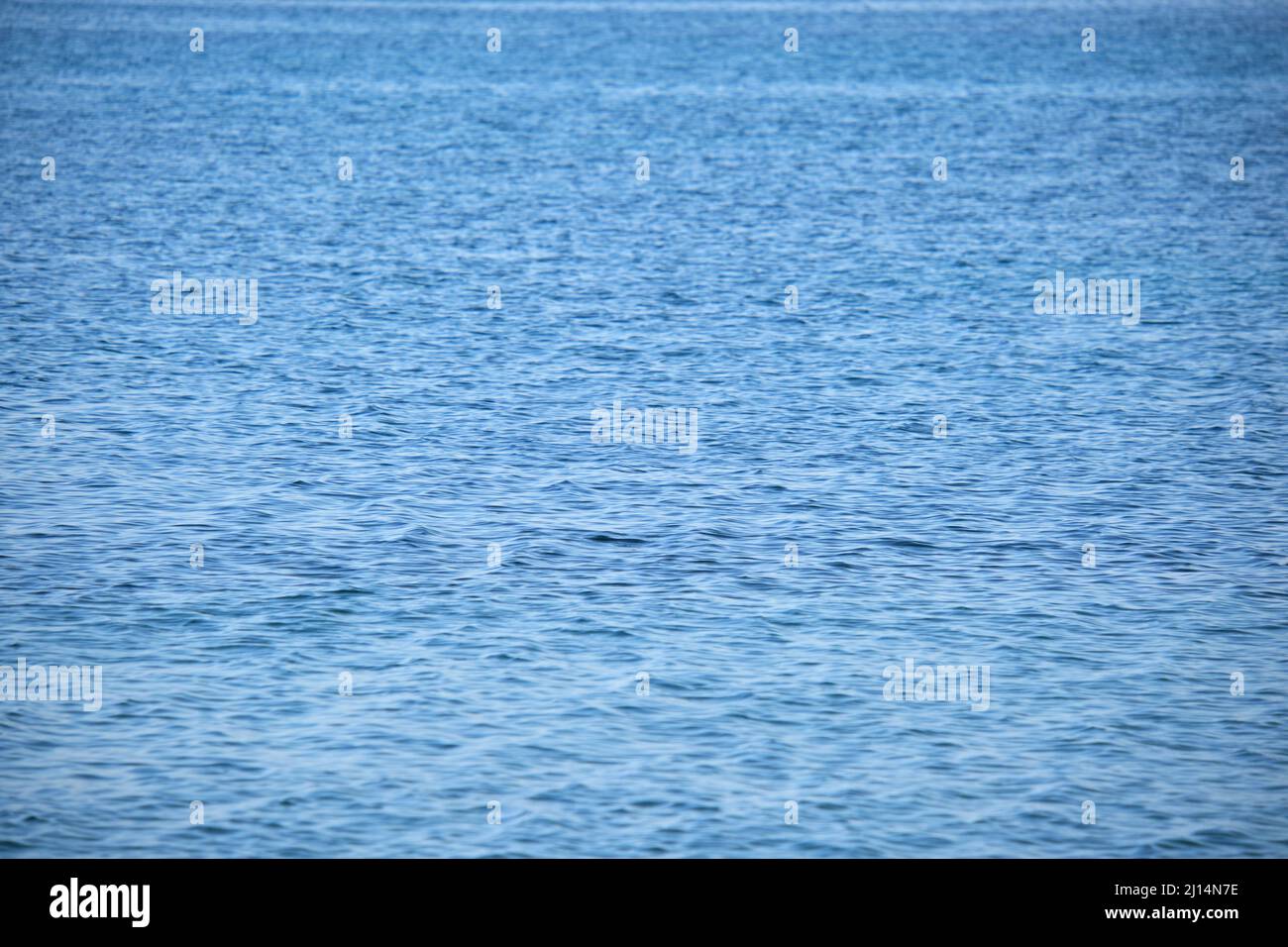 Closeup seascape surface of blue sea water with small ripple waves ...