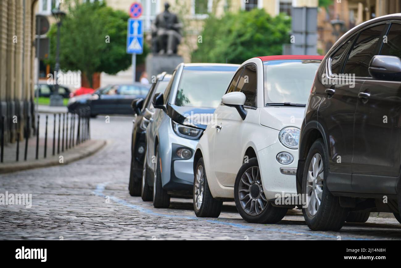 City traffic with cars parked in line on street side Stock Photo - Alamy