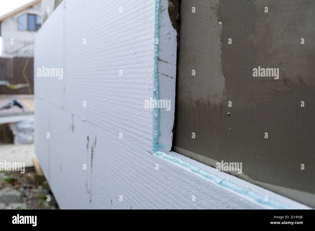 Installation of styrofoam insulation sheets on house facade wall for ...