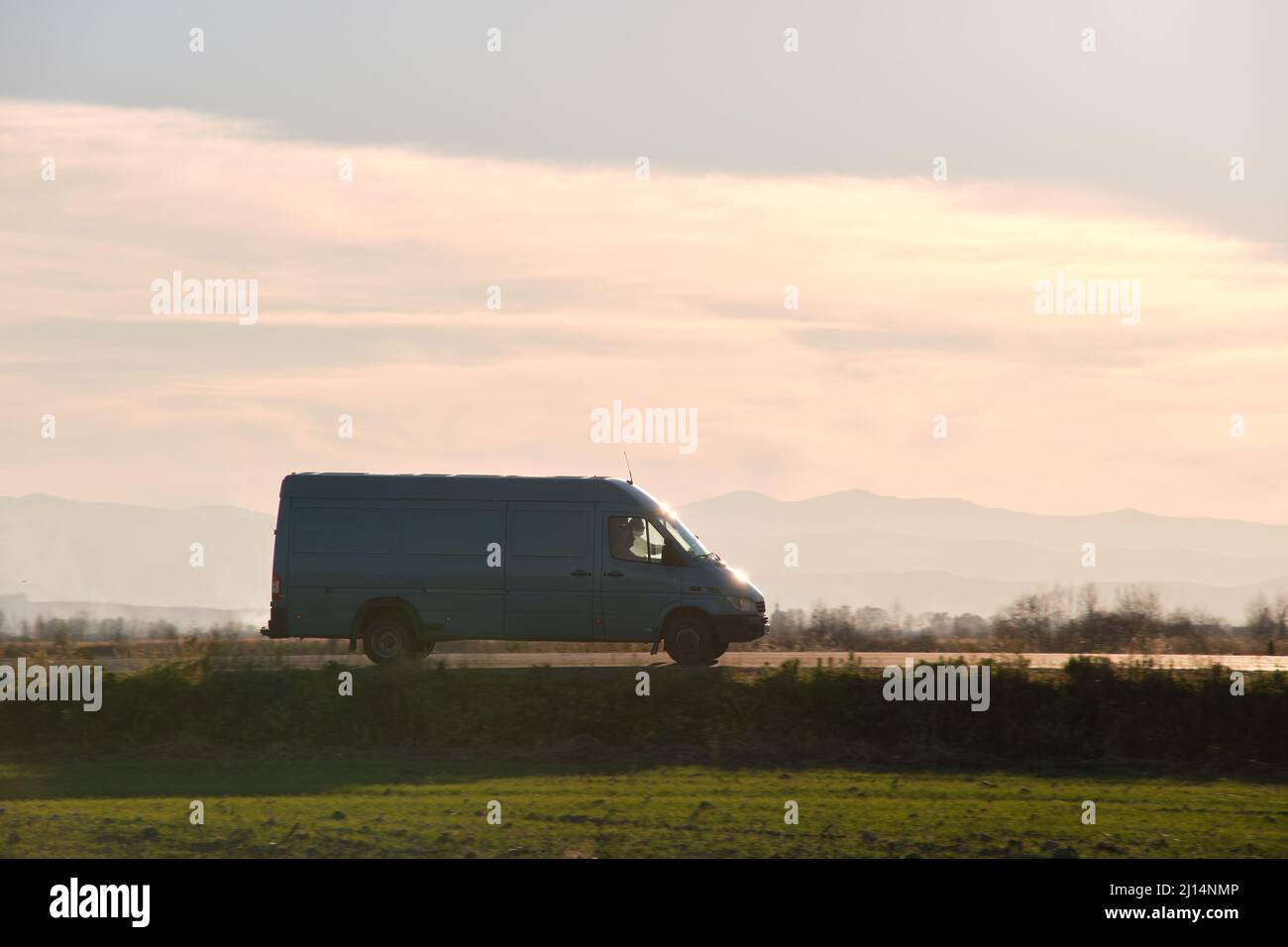 Small cargo van driving on highway hauling goods. Delivery ...