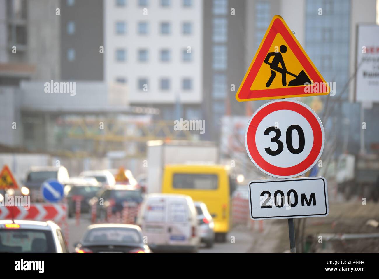 Roadworks warning traffic signs of construction work on city street and ...