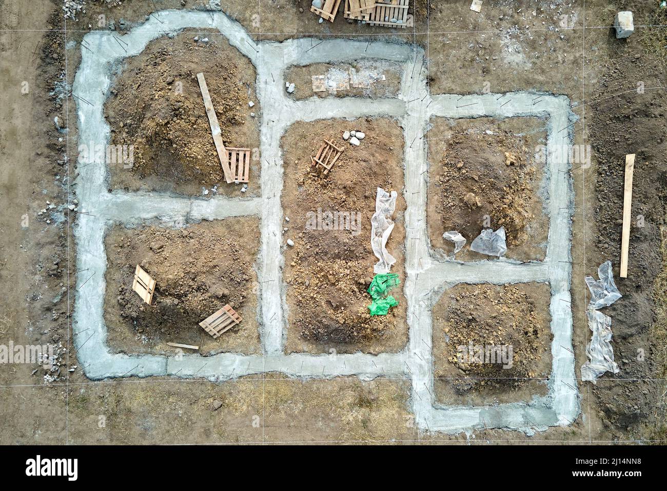 Top down aerial view of building works of new house concrete foundation ...