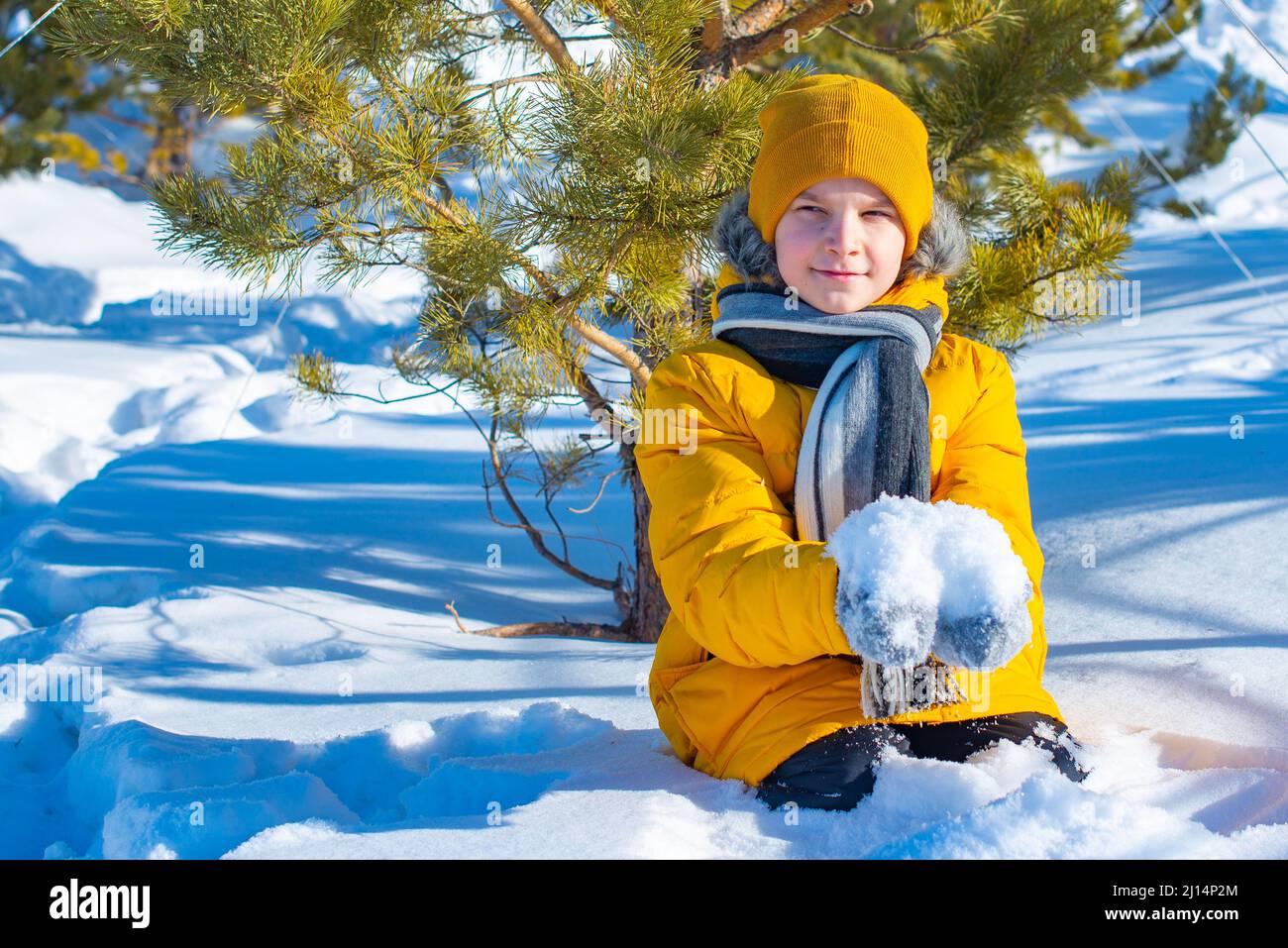 boy in a yellow jacket in the snow Stock Photo - Alamy