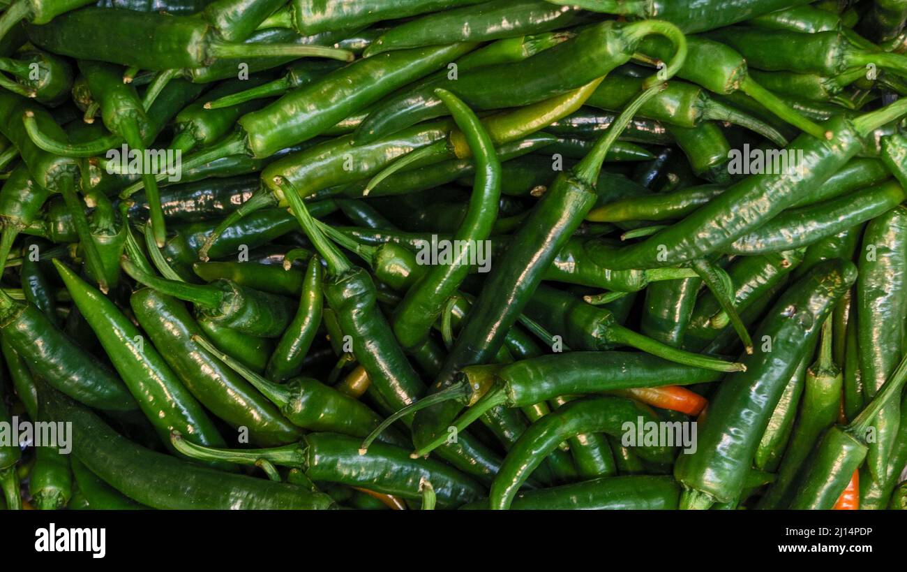 Green chili pepper background top view Stock Photo - Alamy