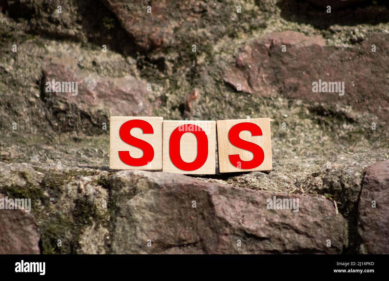 Wooden blocks forming the letters SOS isolated on white background ...