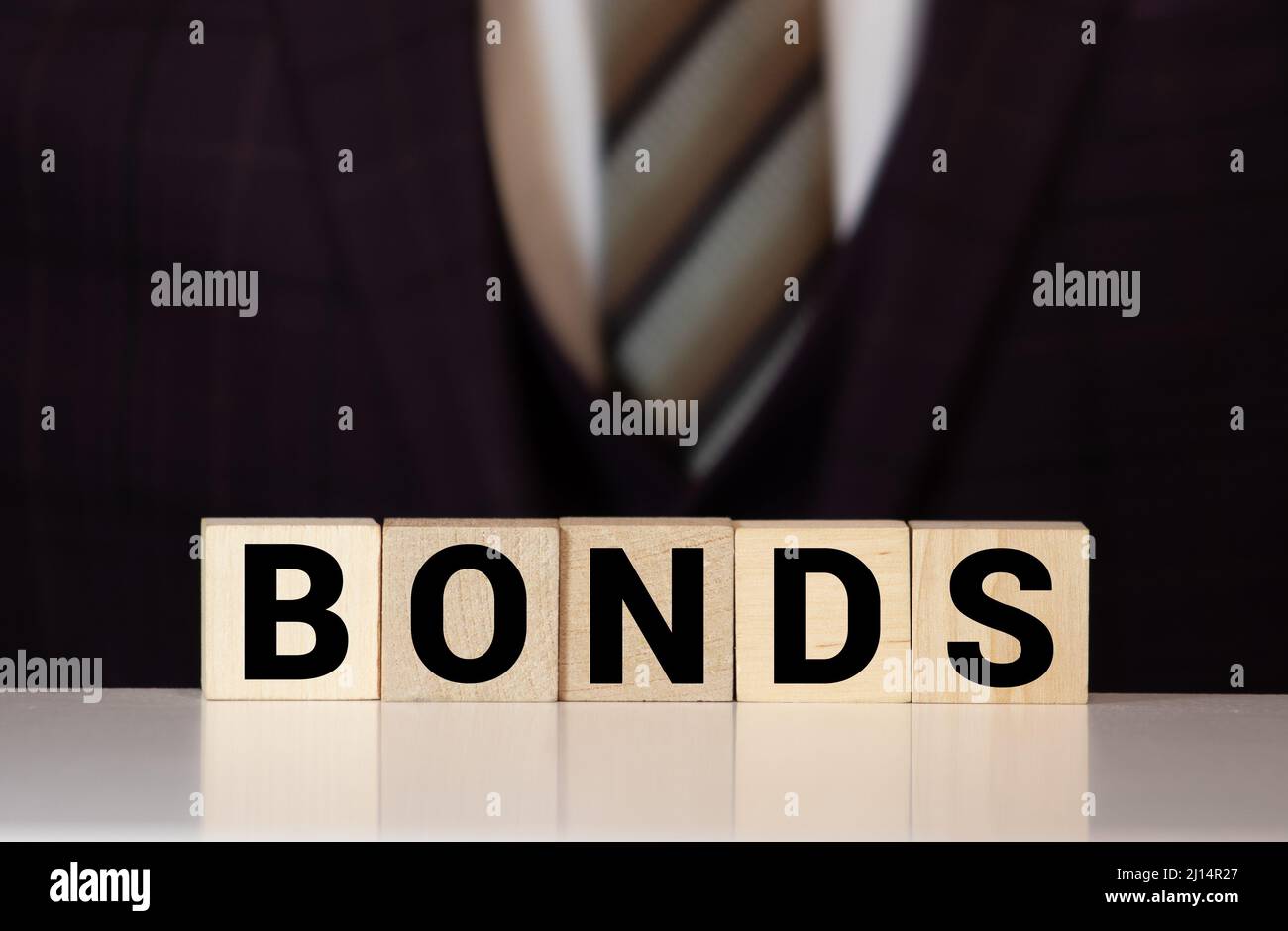 Word BONDS in wooden block on US Dollar bills Stock Photo - Alamy