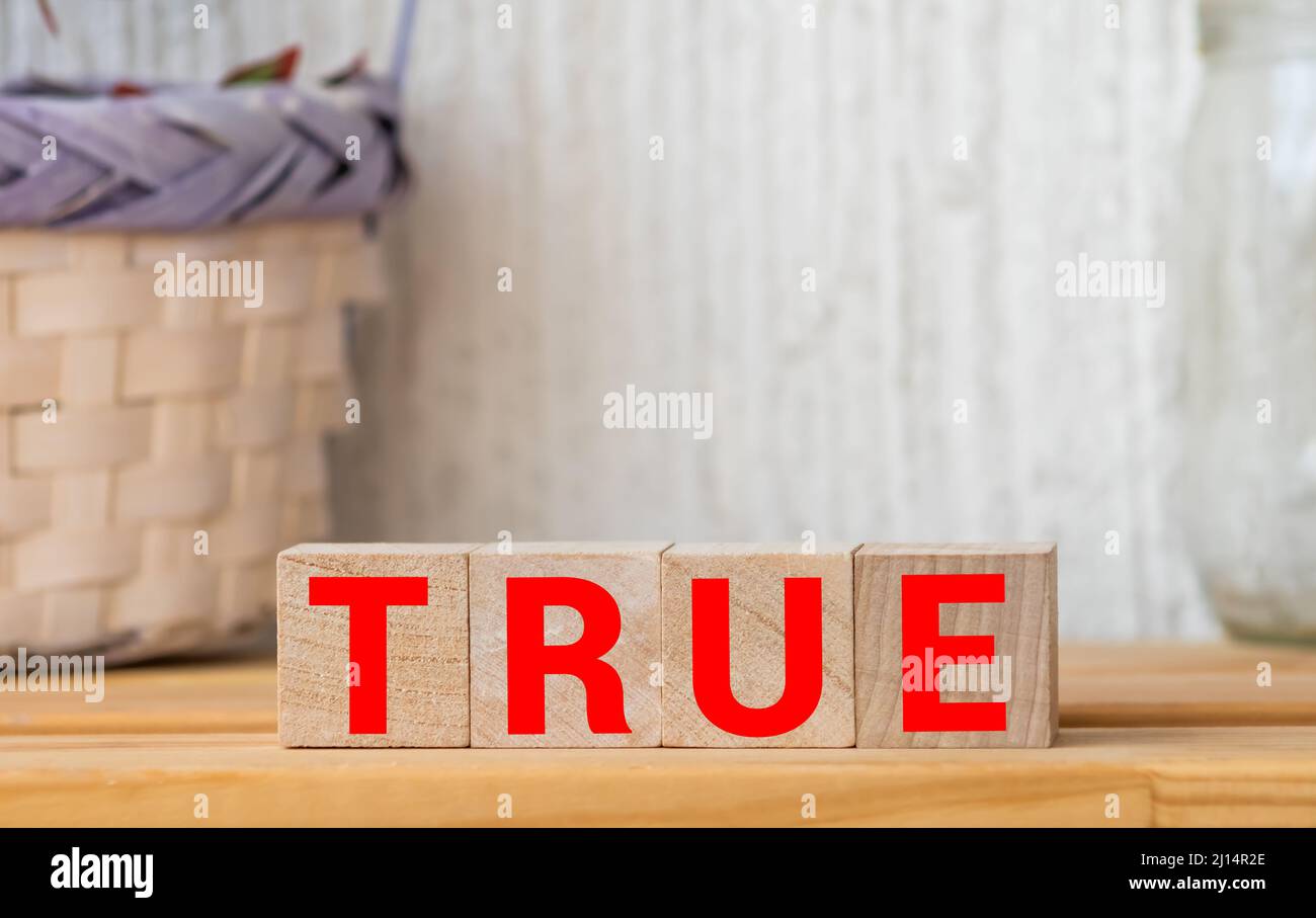 Letter block in word true on wood background Stock Photo - Alamy