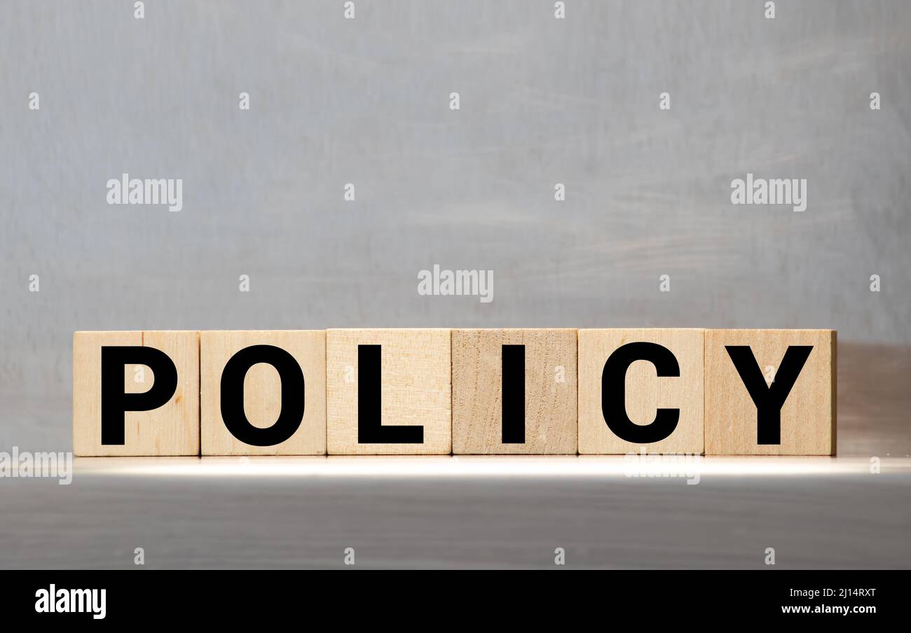 policy word written on wood block, concept Stock Photo - Alamy