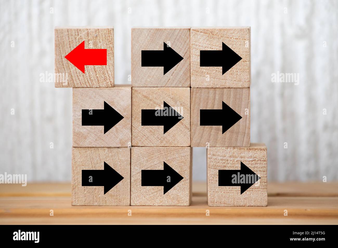 Hand flip over wooden cube block with red arrow facing the opposite ...