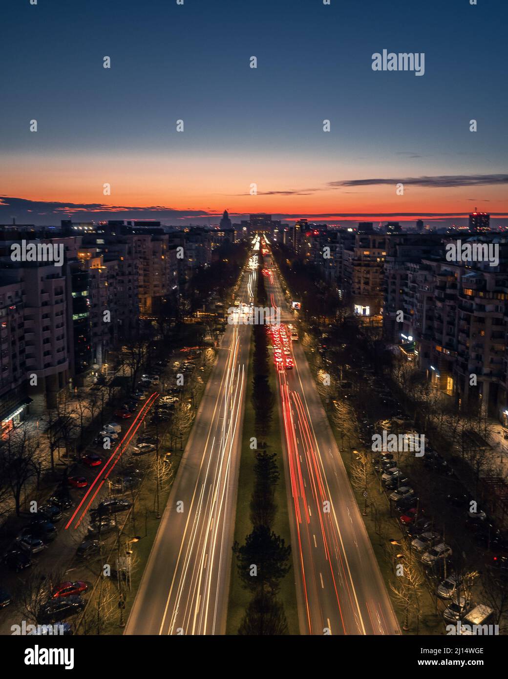 Aerial view of a city with illuminated streets and roads with traffic ...