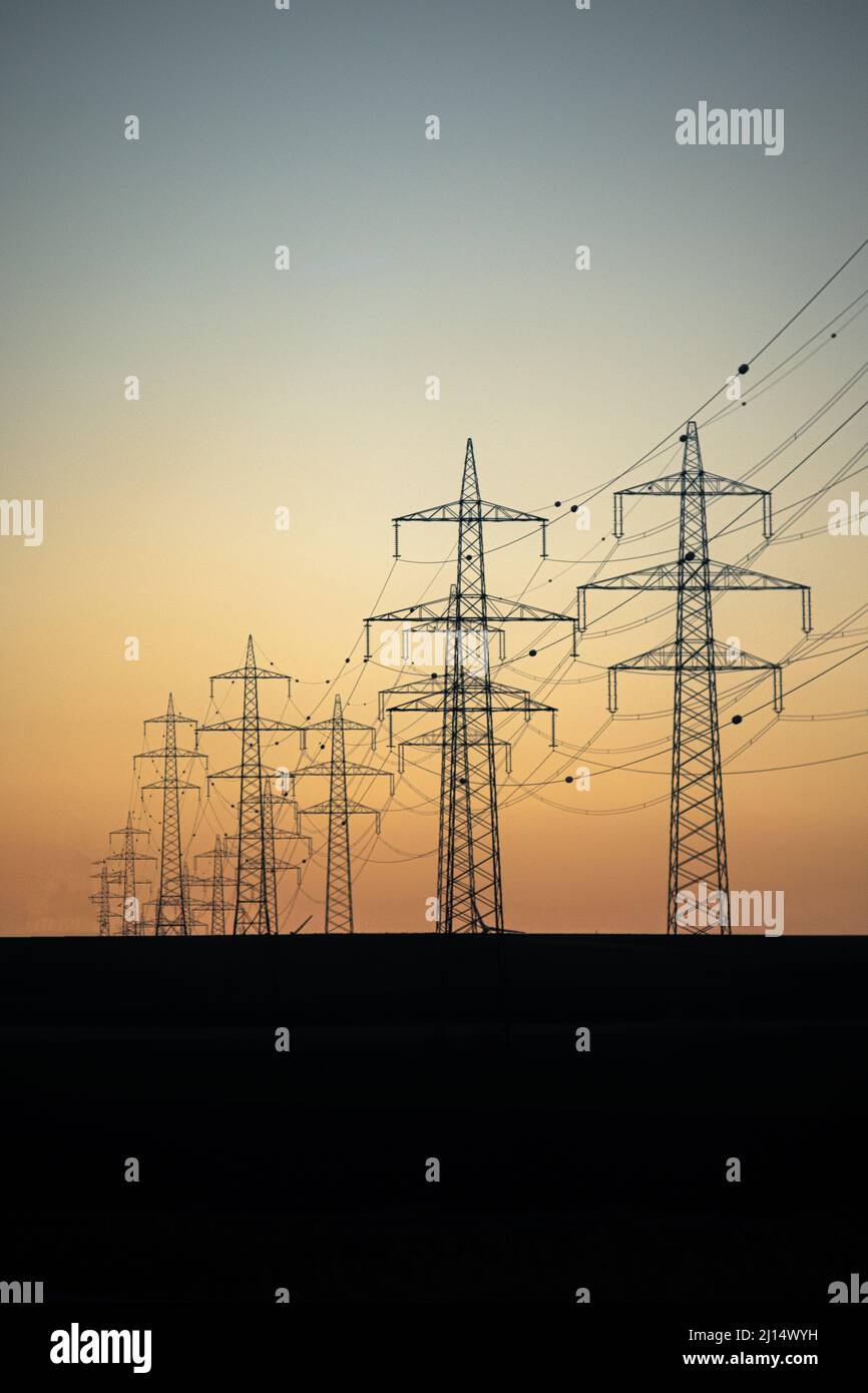 Vertical shot of electricity supplements line view with the orange ...