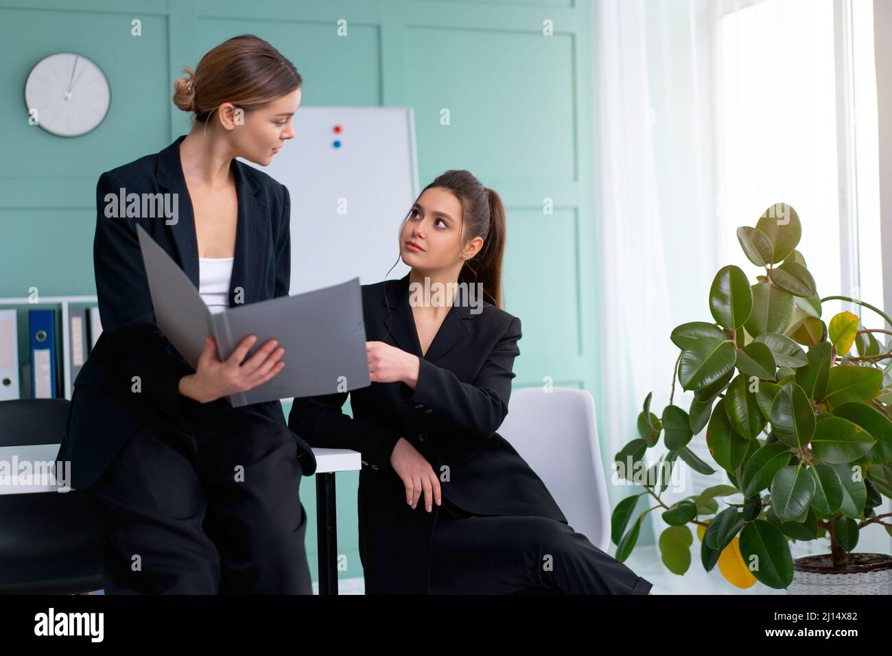 Young women leaders are checking financial statements from paper ...