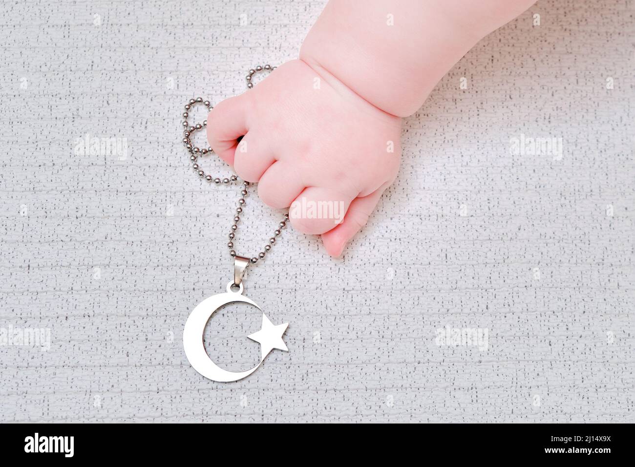 Baby hand and islamic religious symbol, close-up. Children fingers and ...