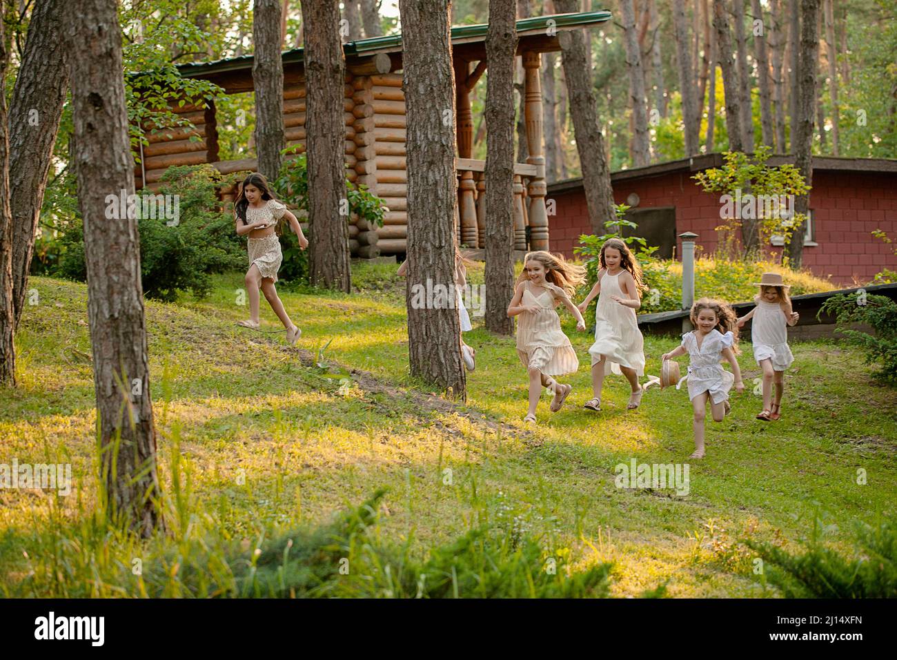 Group of cheerful tween girls running in green summer park Stock Photo ...