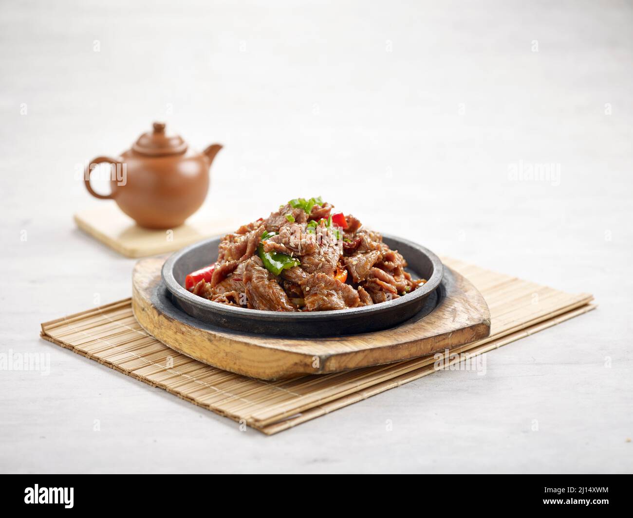 Hot-Plate Mutton with Cumin in a dish isolated on wooden board side ...