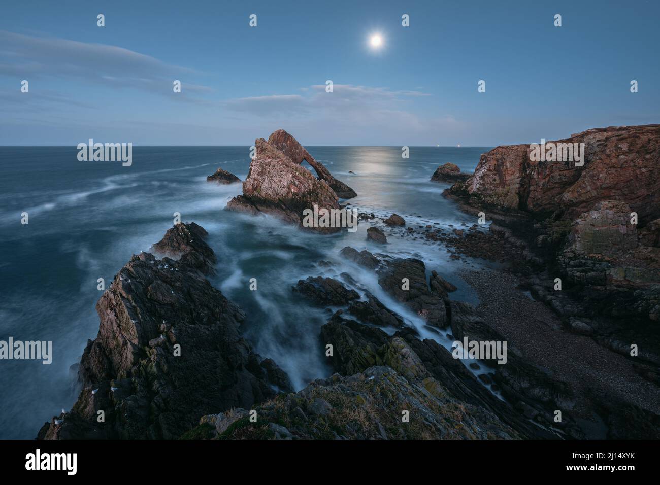 Stunning view of the sea cliffs by moonlight on the northern Scottish ...