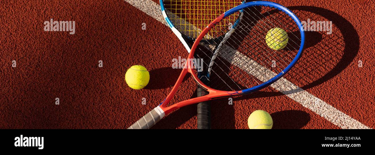A tennis racket and new tennis ball on a freshly painted tennis court ...