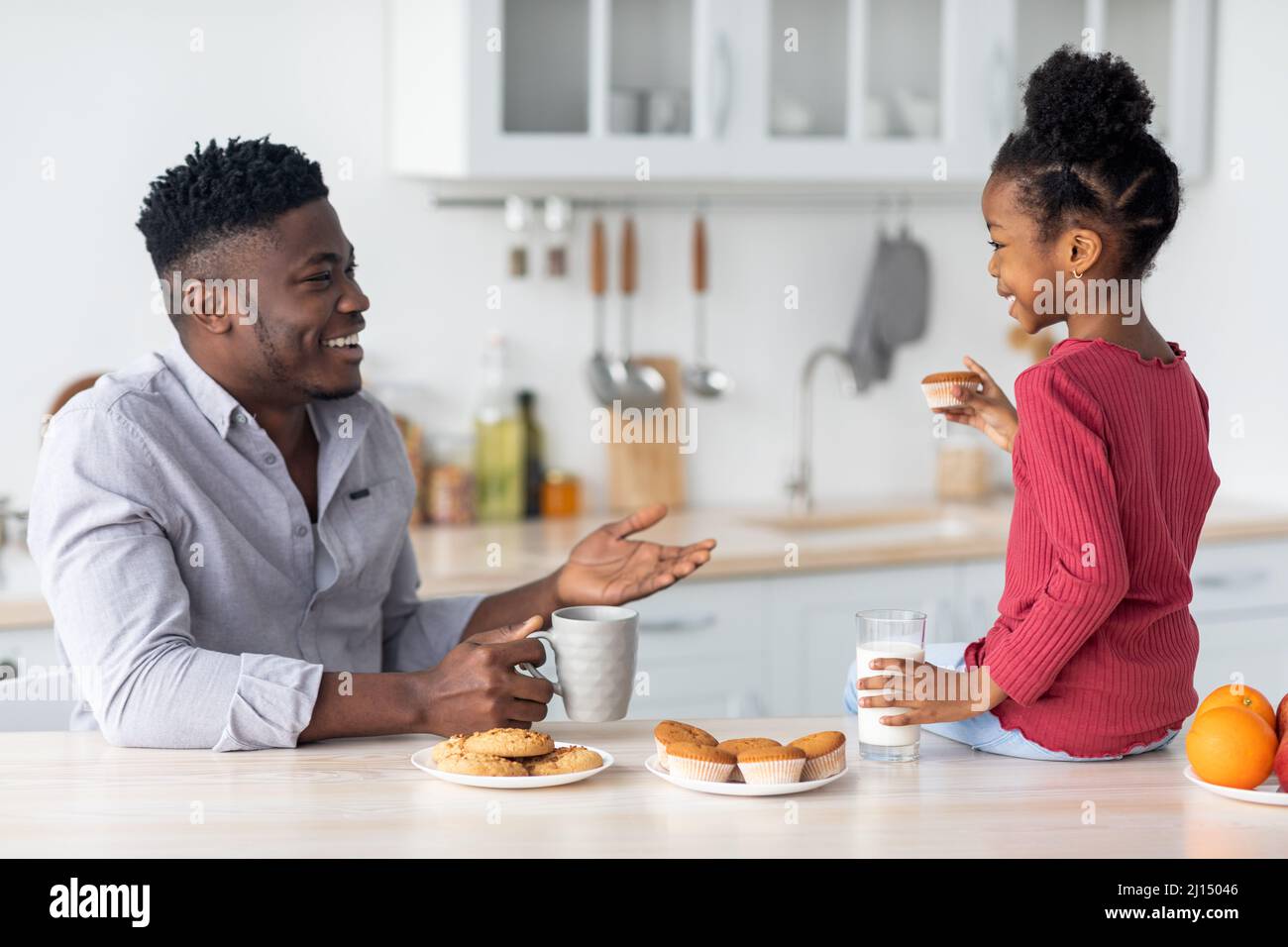 Friendly african american family chatting while having snack Stock ...