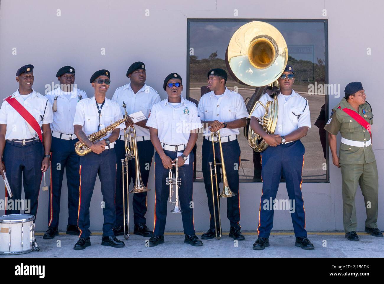 Members of the Belize military wait in the shade before the departure ...