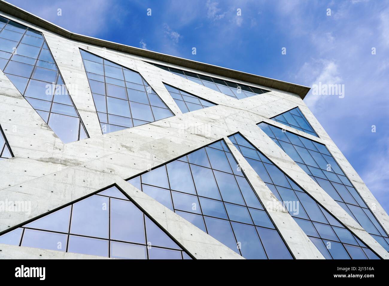 A Fragment Of The Facade Of A Modern Design Glass And Concrete Building Against A Background Of