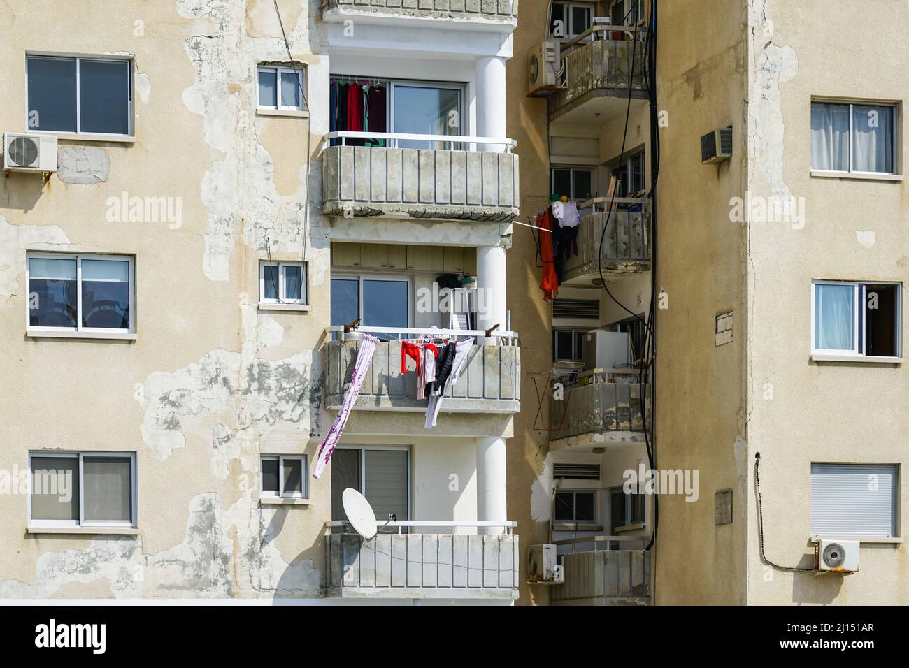 fragment of the facade of a dilapidated apartment house with fallen ...