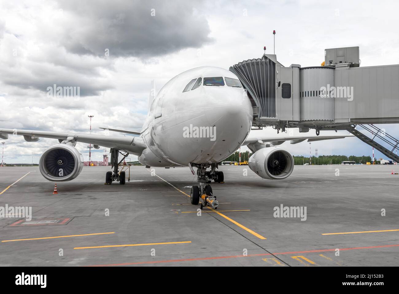 Passenger airplane in the parking at the airport with a nose forward ...