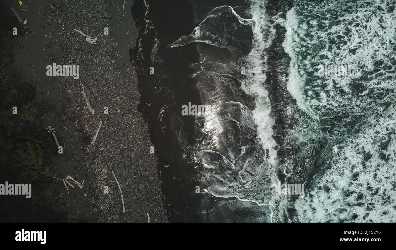 Aerial view of the wavy sea hitting the sandy beach on the coast Stock ...