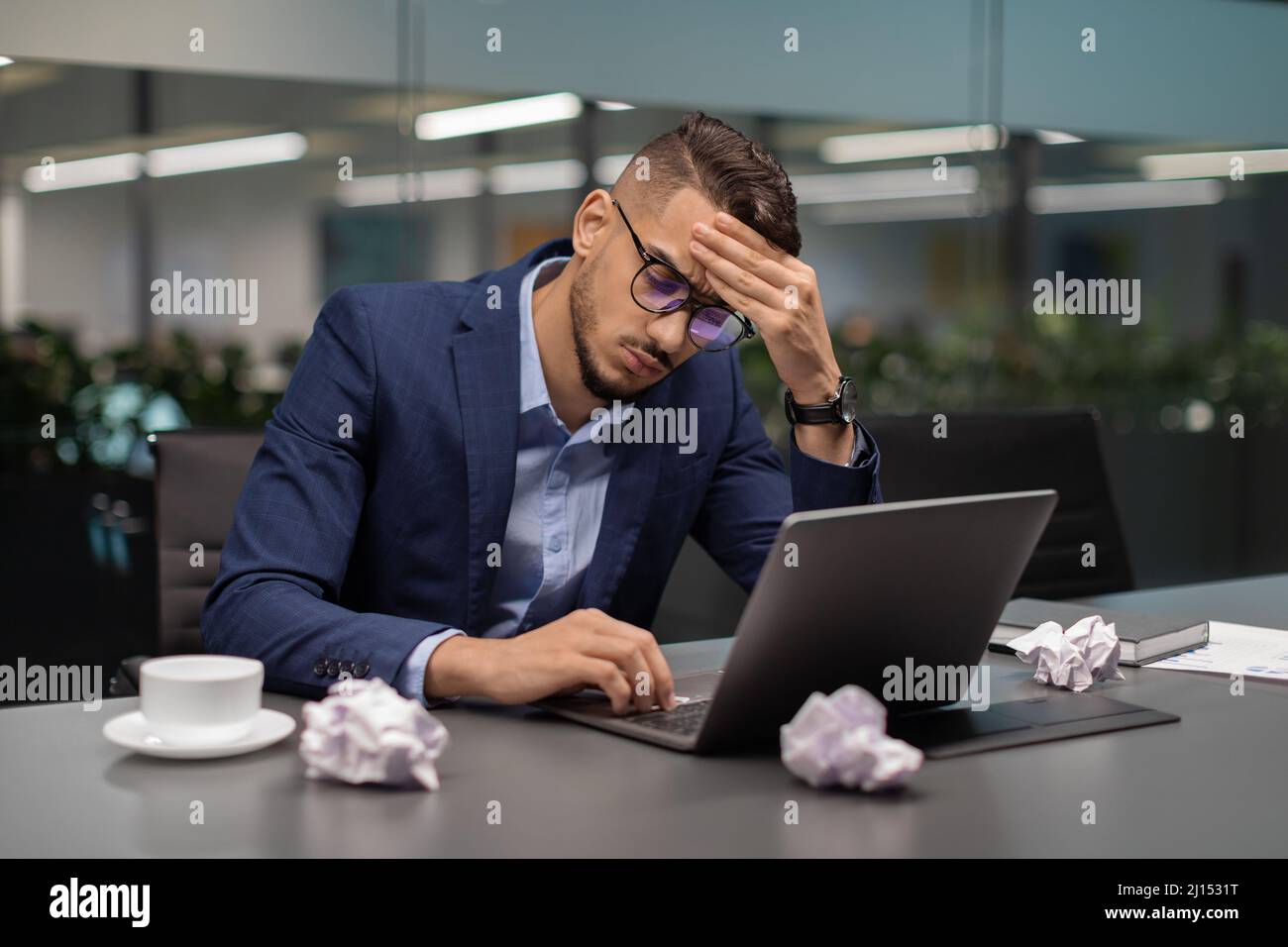 Tired arab man project manager sitting in front of computer Stock Photo ...