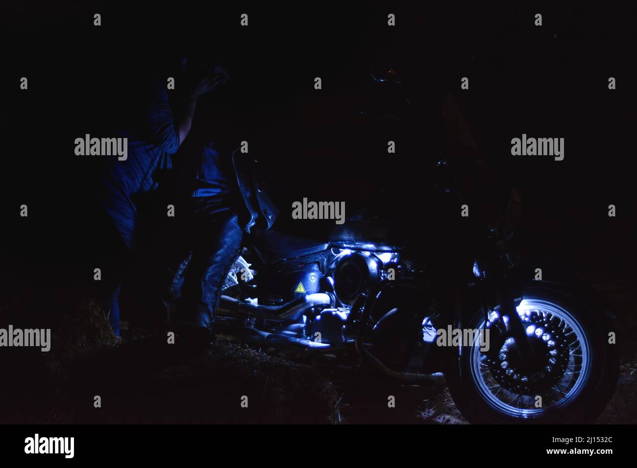 Biker motorcycle in neon lights at night. Motorcycle silhouette in the ...