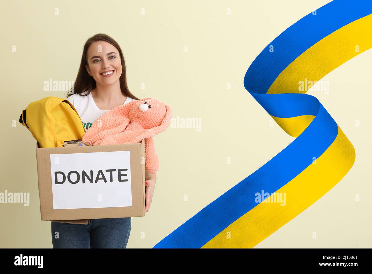 Female volunteer with donation box and ribbon in colors of Ukrainian ...