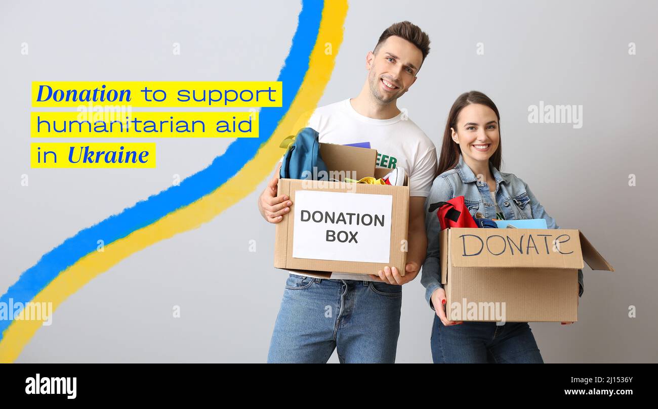 Volunteers with donation boxes and ribbon in colors of Ukrainian flag ...