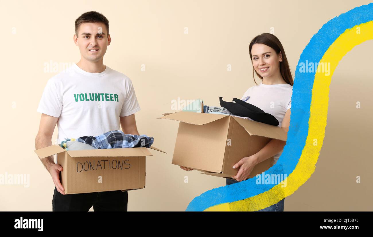 Volunteers with donation boxes and ribbon in colors of Ukrainian flag ...