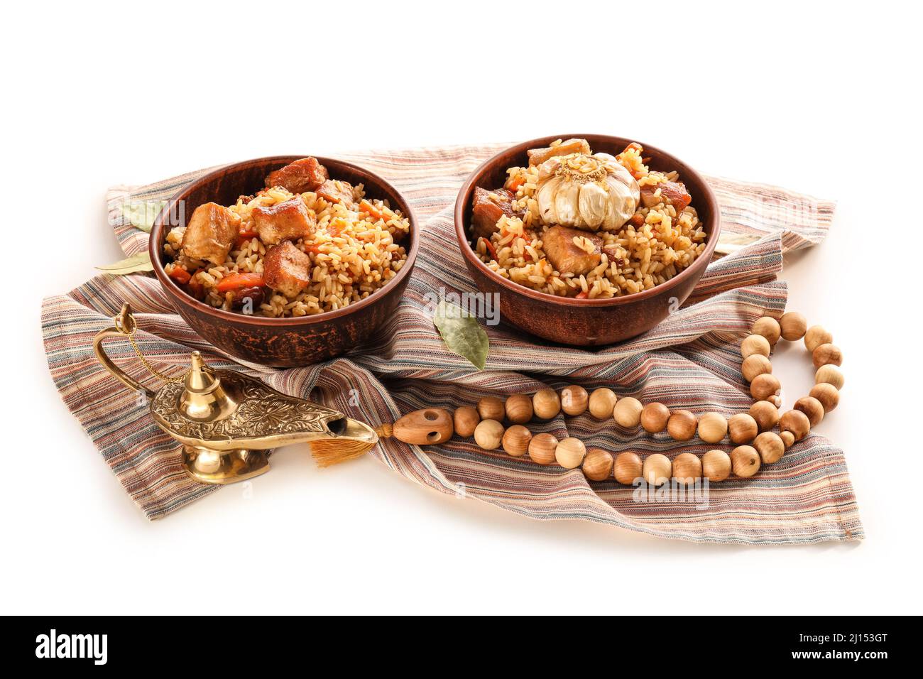 Bowls with tasty Asian pilaf on white background Stock Photo - Alamy