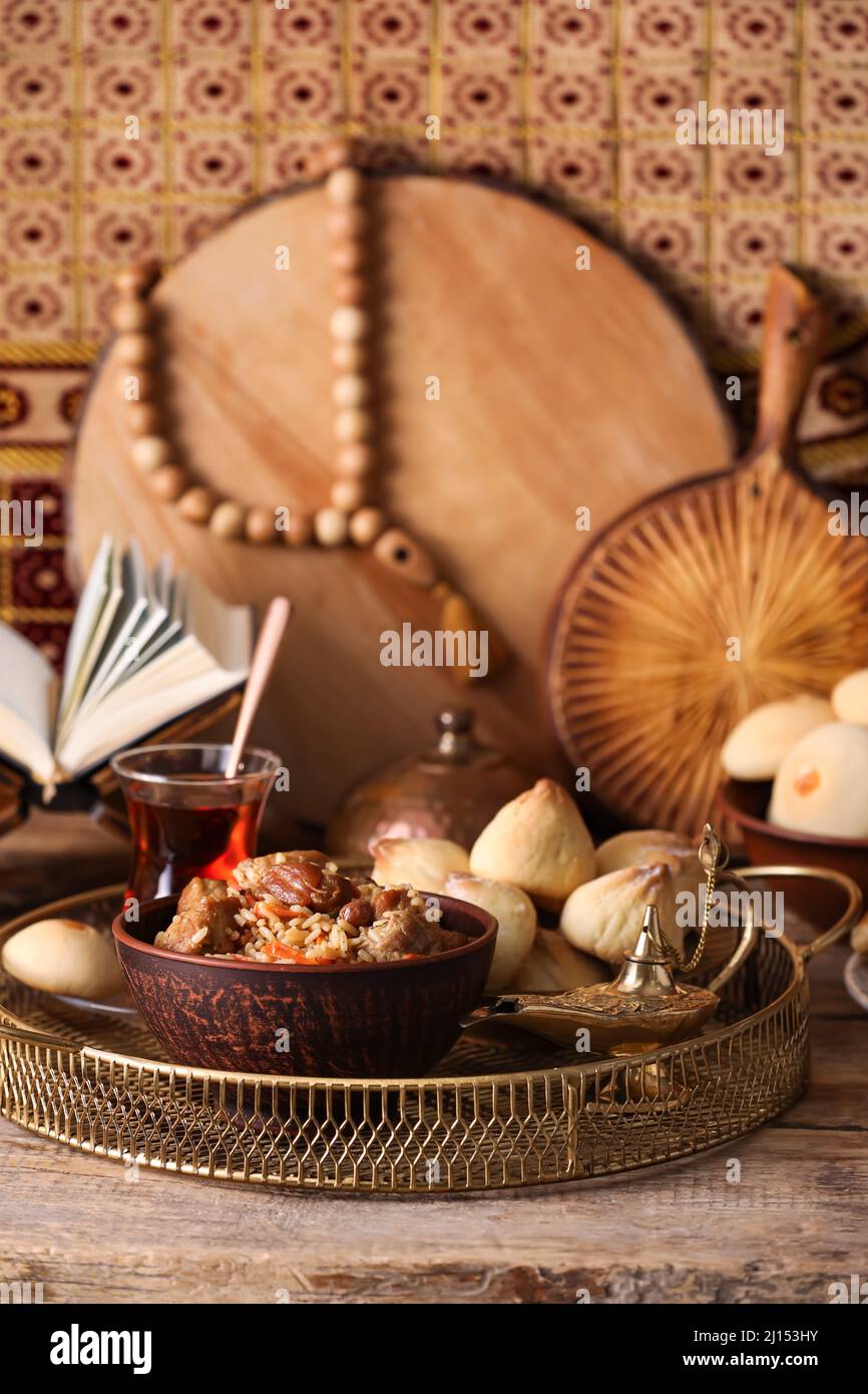 Tray with traditional Eastern dishes and Aladdin lamp on table Stock ...