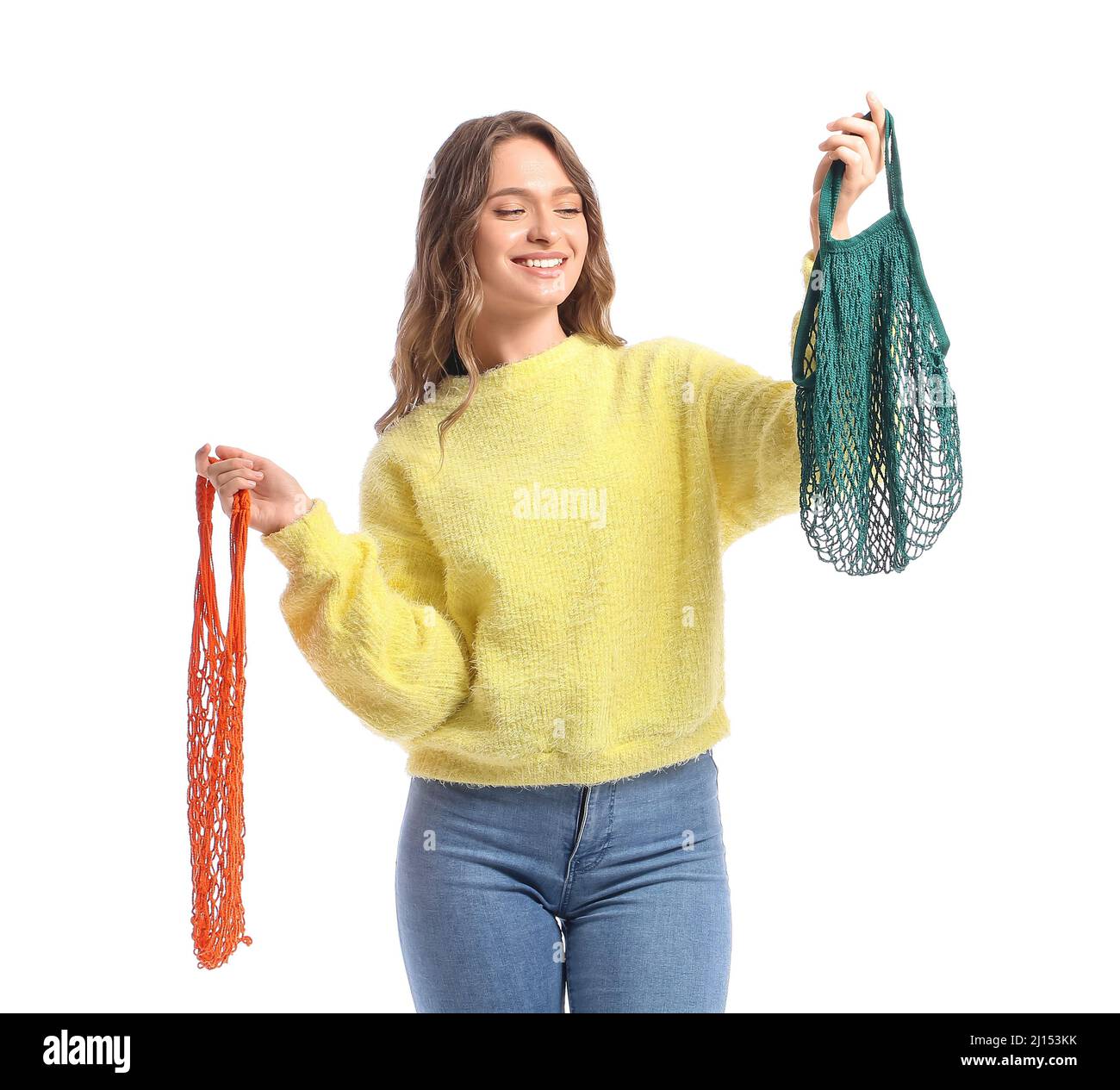 Young woman with string bags on white background Stock Photo - Alamy
