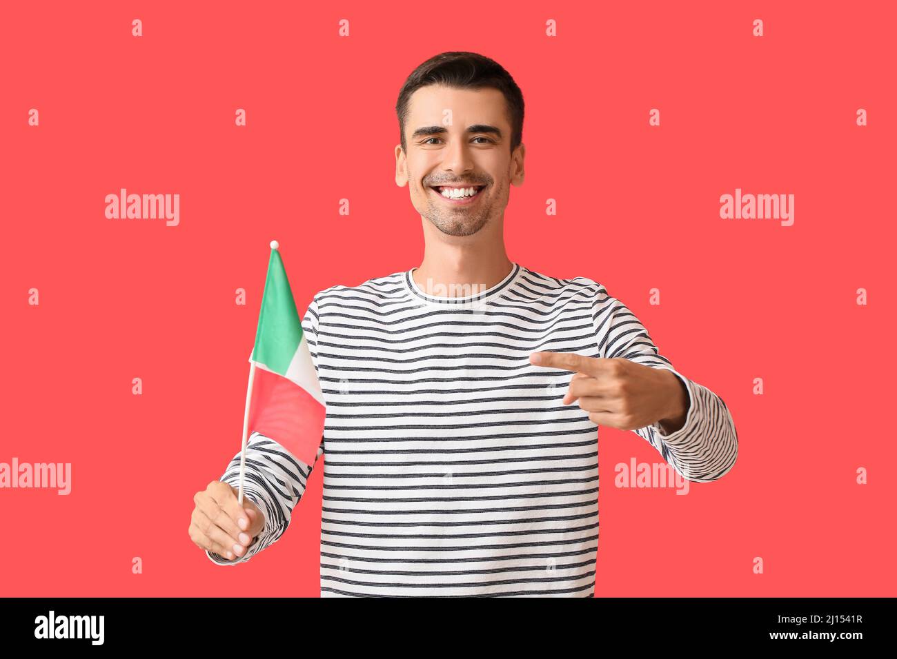 Young man with Italian flag on color background Stock Photo - Alamy