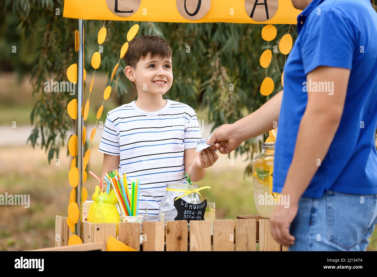 Cute boy selling lemonade in park Stock Photo - Alamy