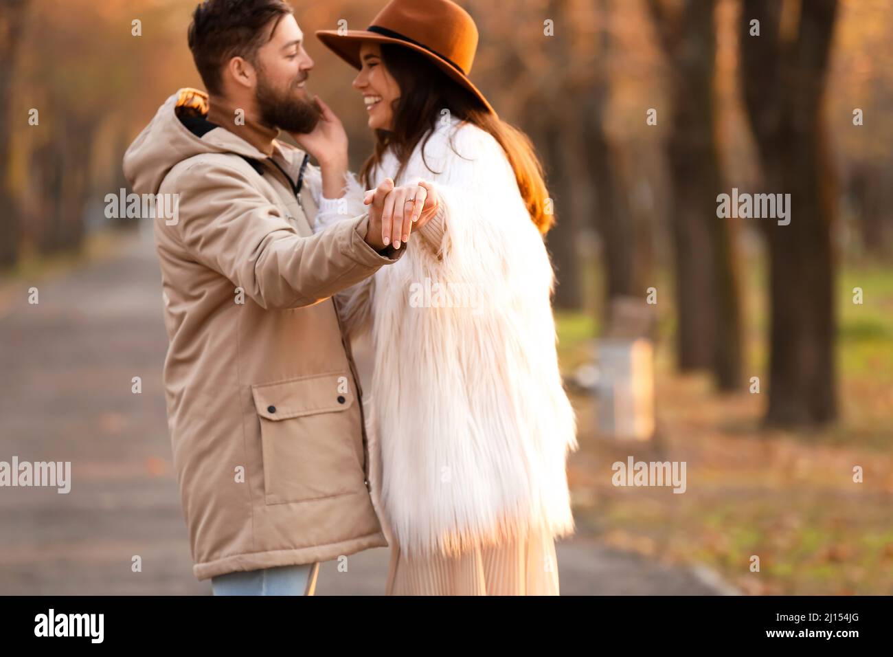 Happy young woman with engagement ring and her fiance in park Stock ...