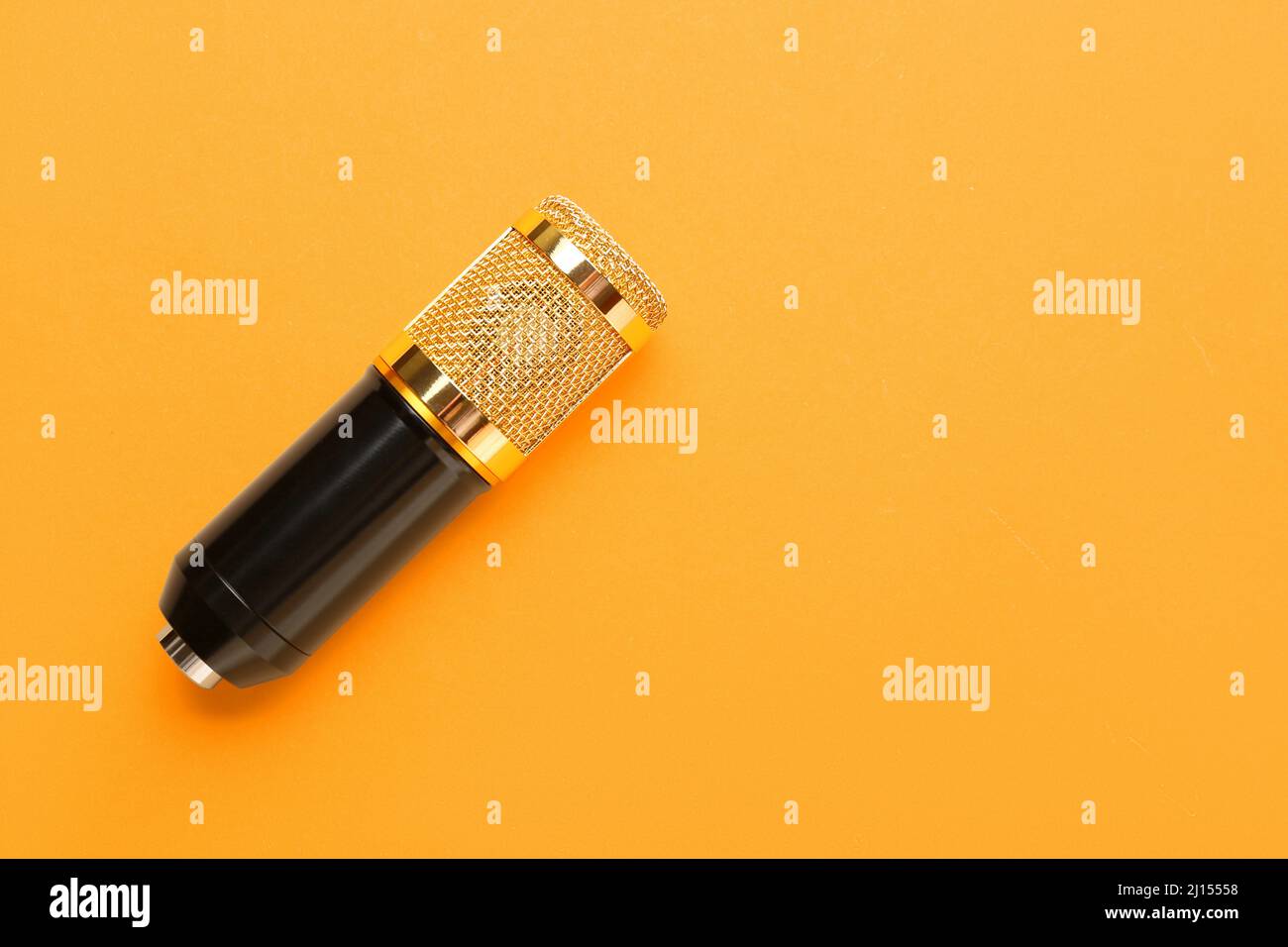 Modern microphone on orange background Stock Photo - Alamy