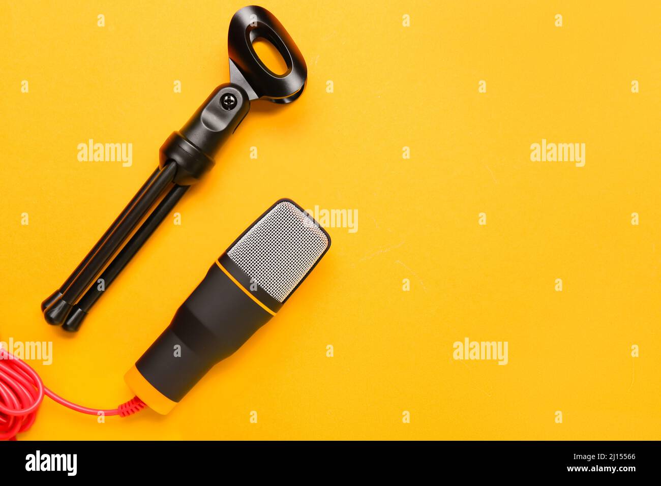Modern microphone and stand on orange background Stock Photo - Alamy
