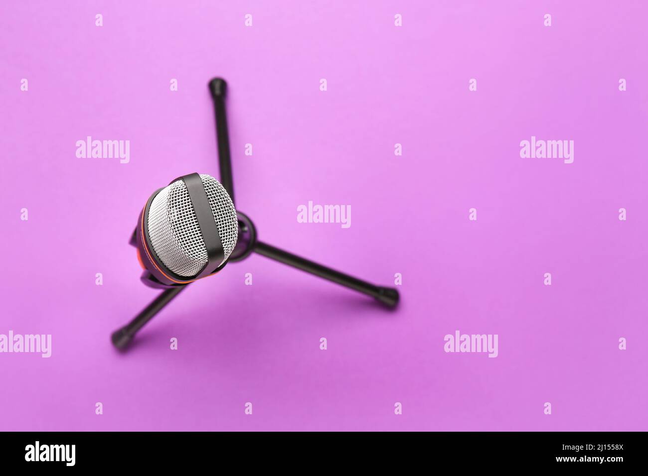 Modern microphone with stand on purple background Stock Photo - Alamy