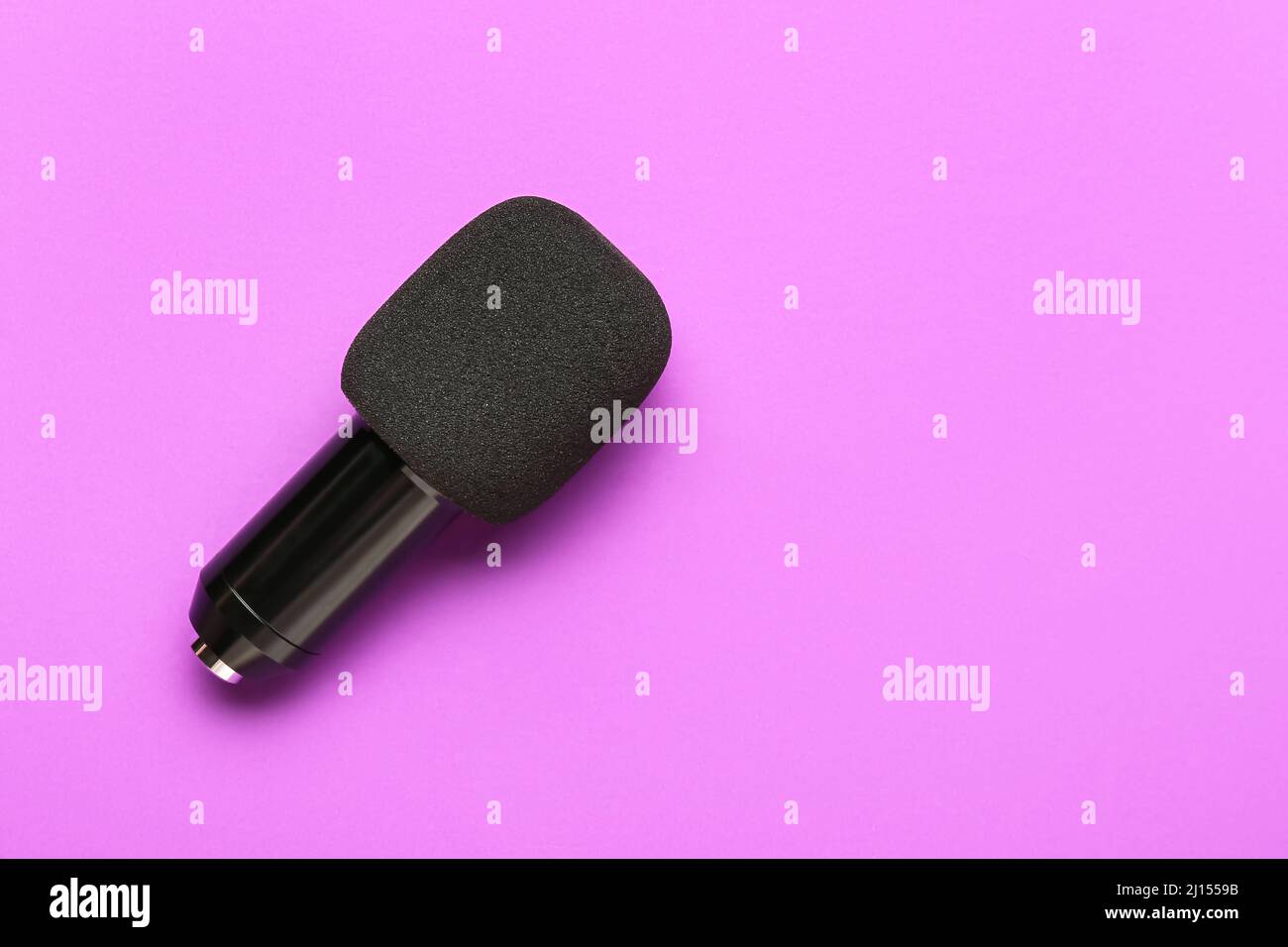 Modern microphone on purple background Stock Photo - Alamy