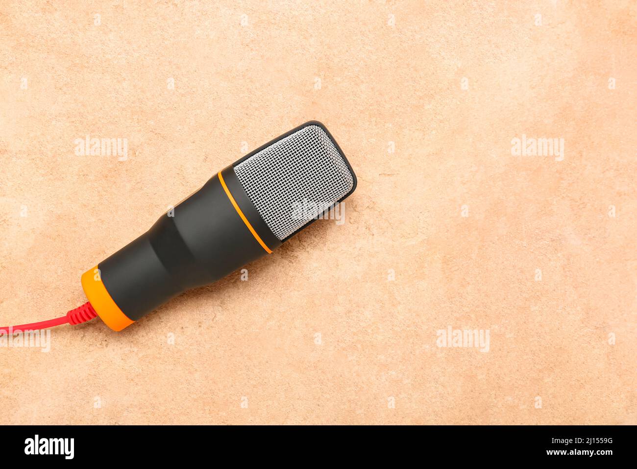 New modern microphone with wire on color background Stock Photo - Alamy