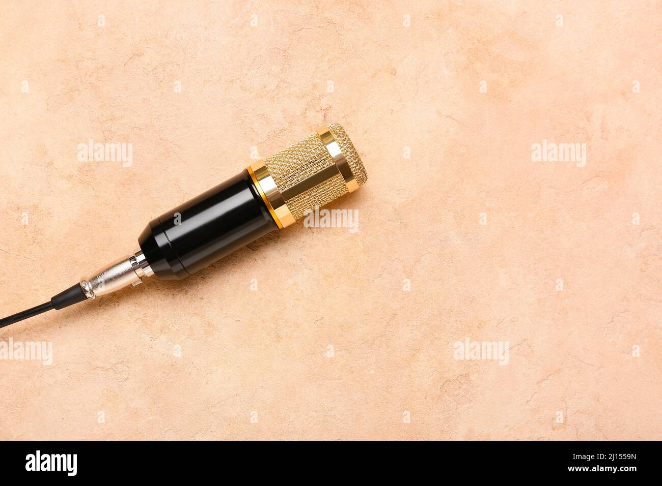 New modern microphone with wire on color background Stock Photo - Alamy