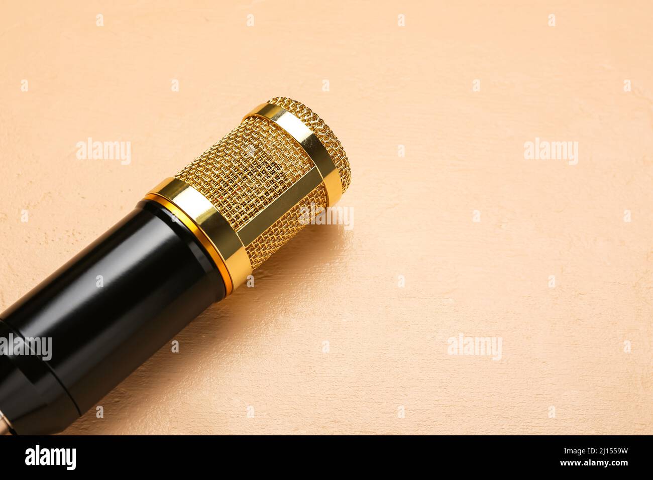 Modern microphone on beige background, closeup Stock Photo - Alamy