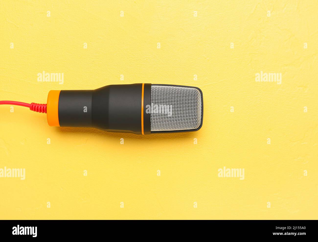 New modern microphone on color background Stock Photo - Alamy